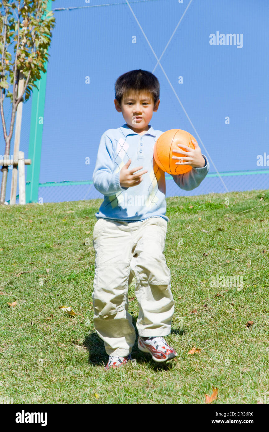 Boy playing with ball Stock Photo - Alamy