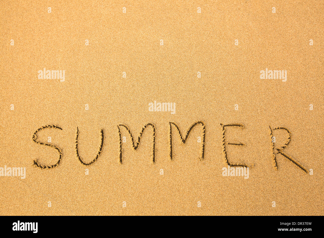 Summer - text written by hand in sand on a beach Stock Photo - Alamy