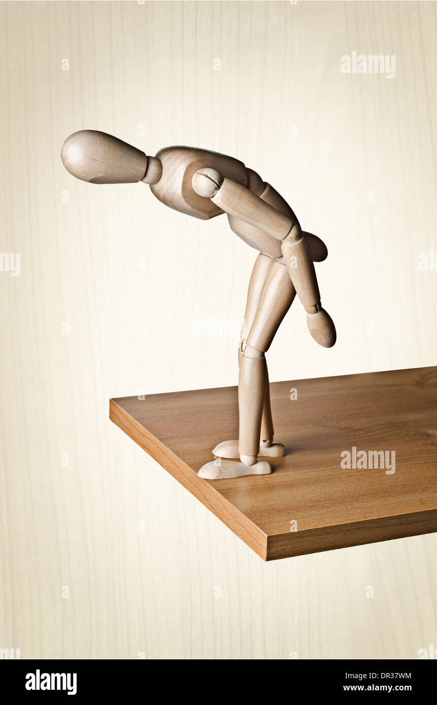 Looking over the edge. Manikin, anatomical model, placed on the edge of ...