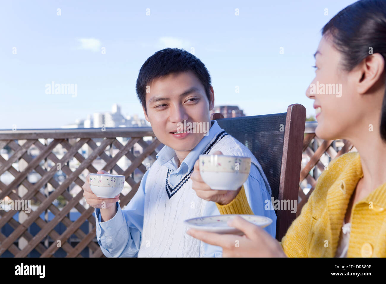 Mid adult couple having tea on balcony Stock Photo - Alamy