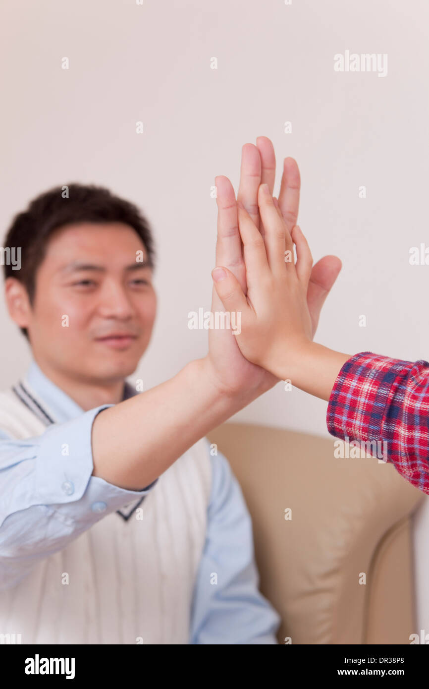 Father and son giving each other high five Stock Photo - Alamy