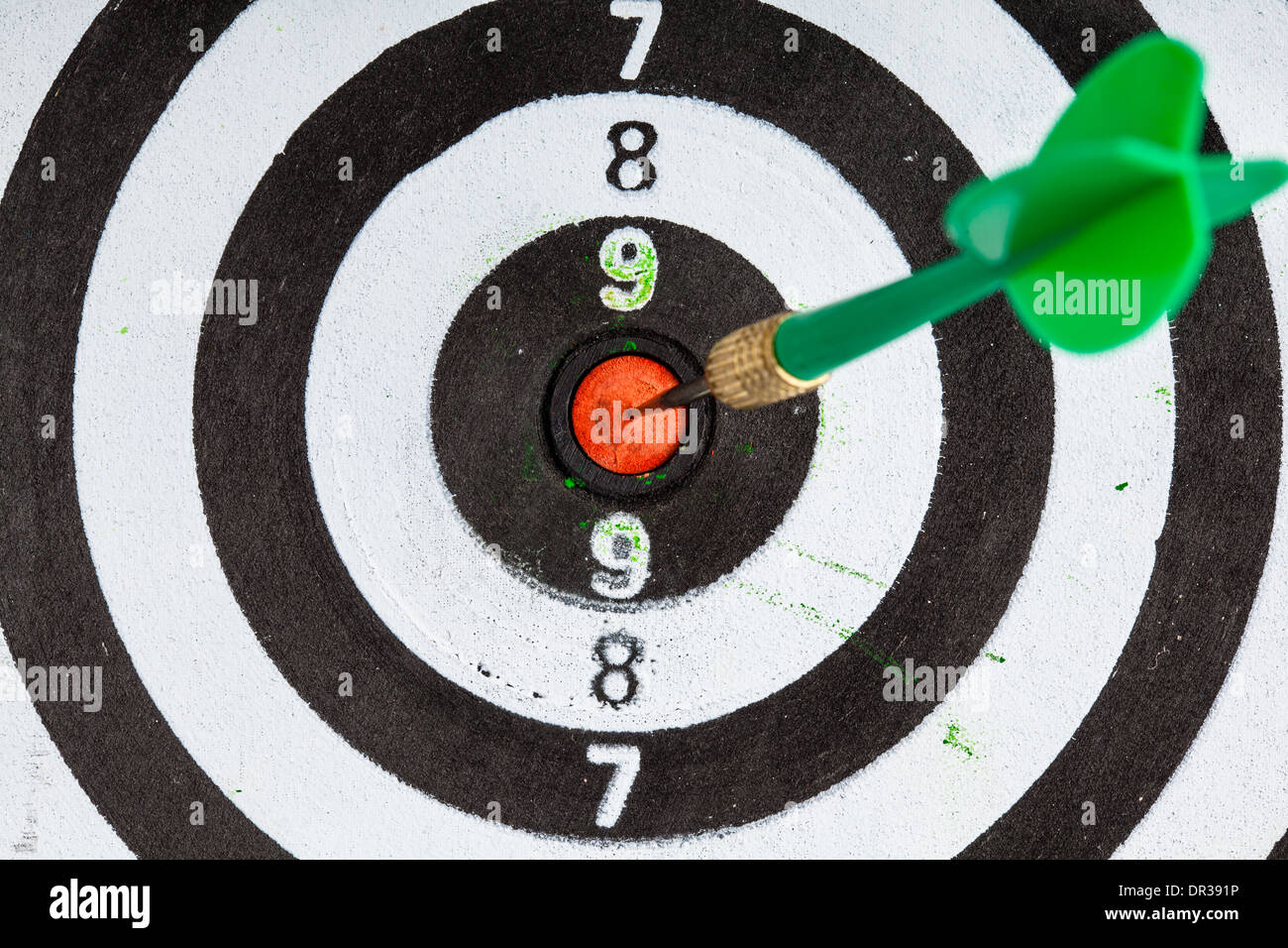 Bullseye. Closeup of old dirty black and white target with dart as ...