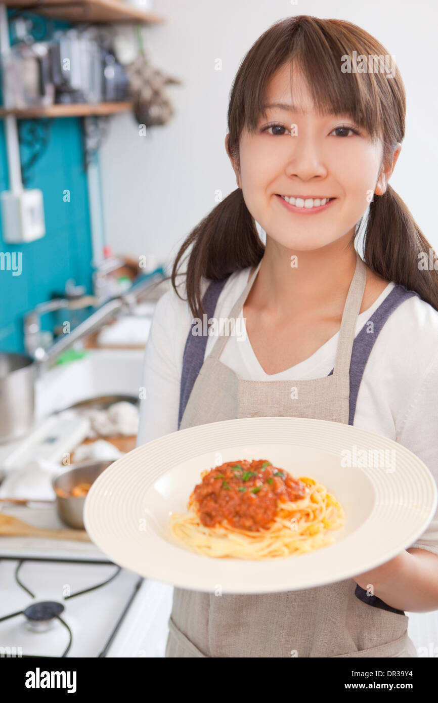 Young woman cooking spaghetti bolognese hi-res stock photography and ...