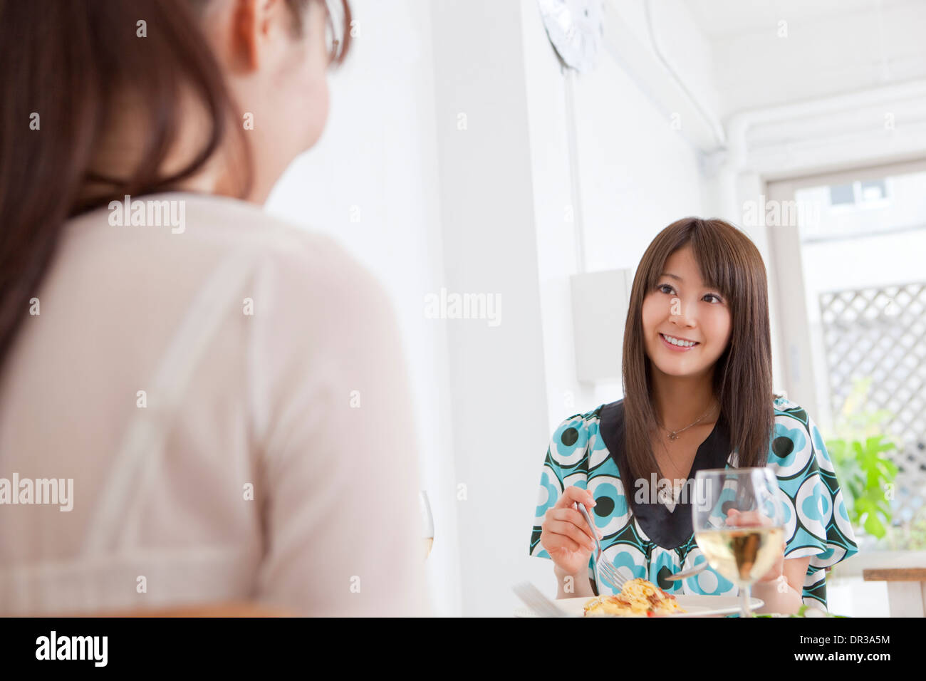 Two young women having lunch Stock Photo - Alamy