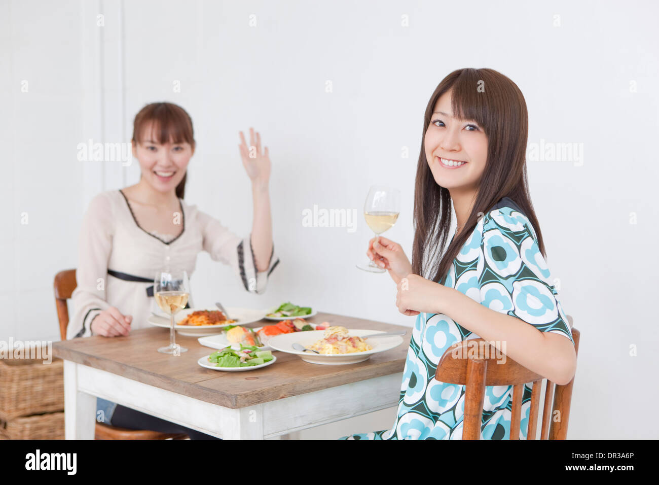 Two young women having lunch Stock Photo - Alamy
