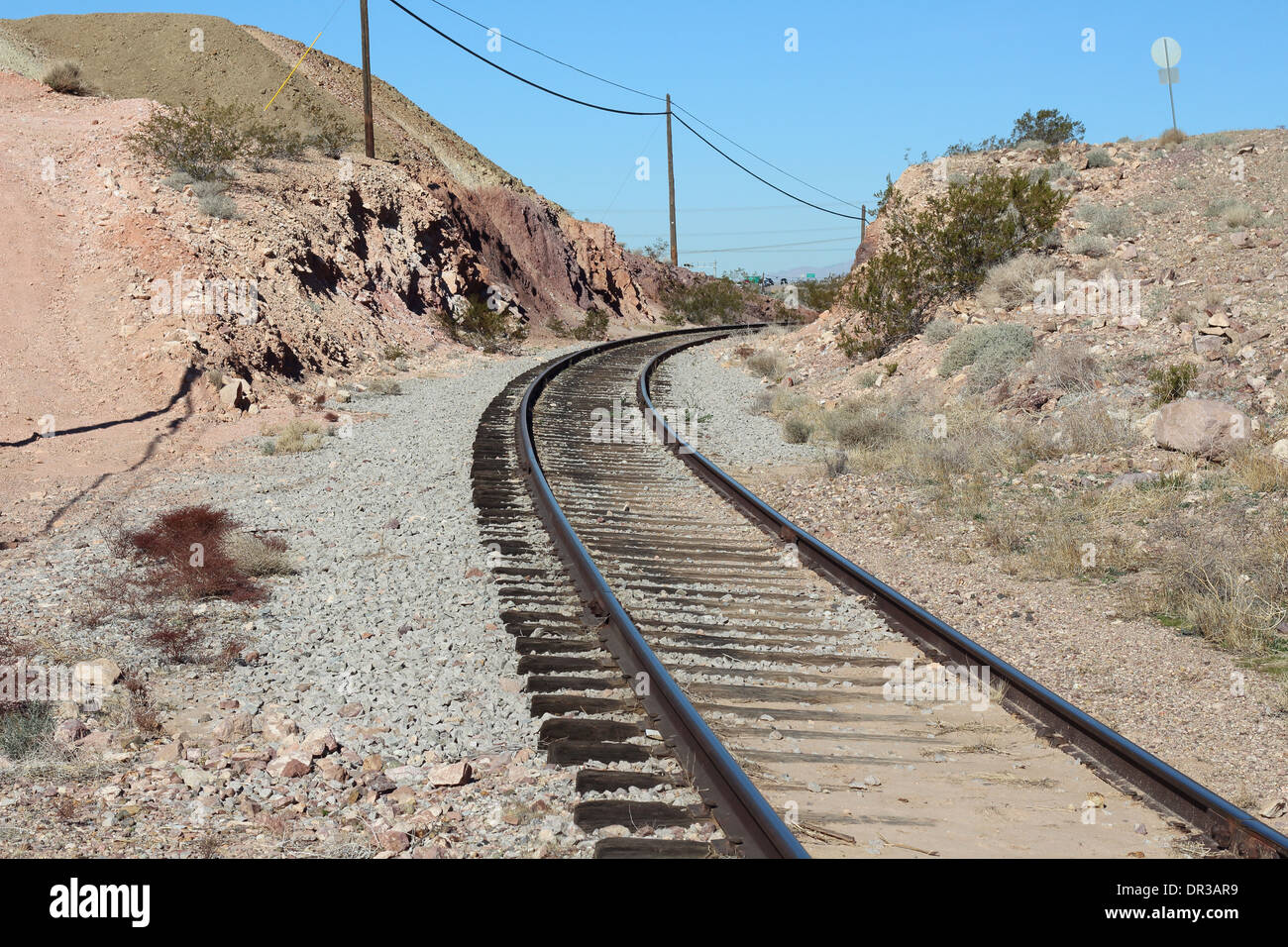 Railroad tracks between a mountain Stock Photo - Alamy