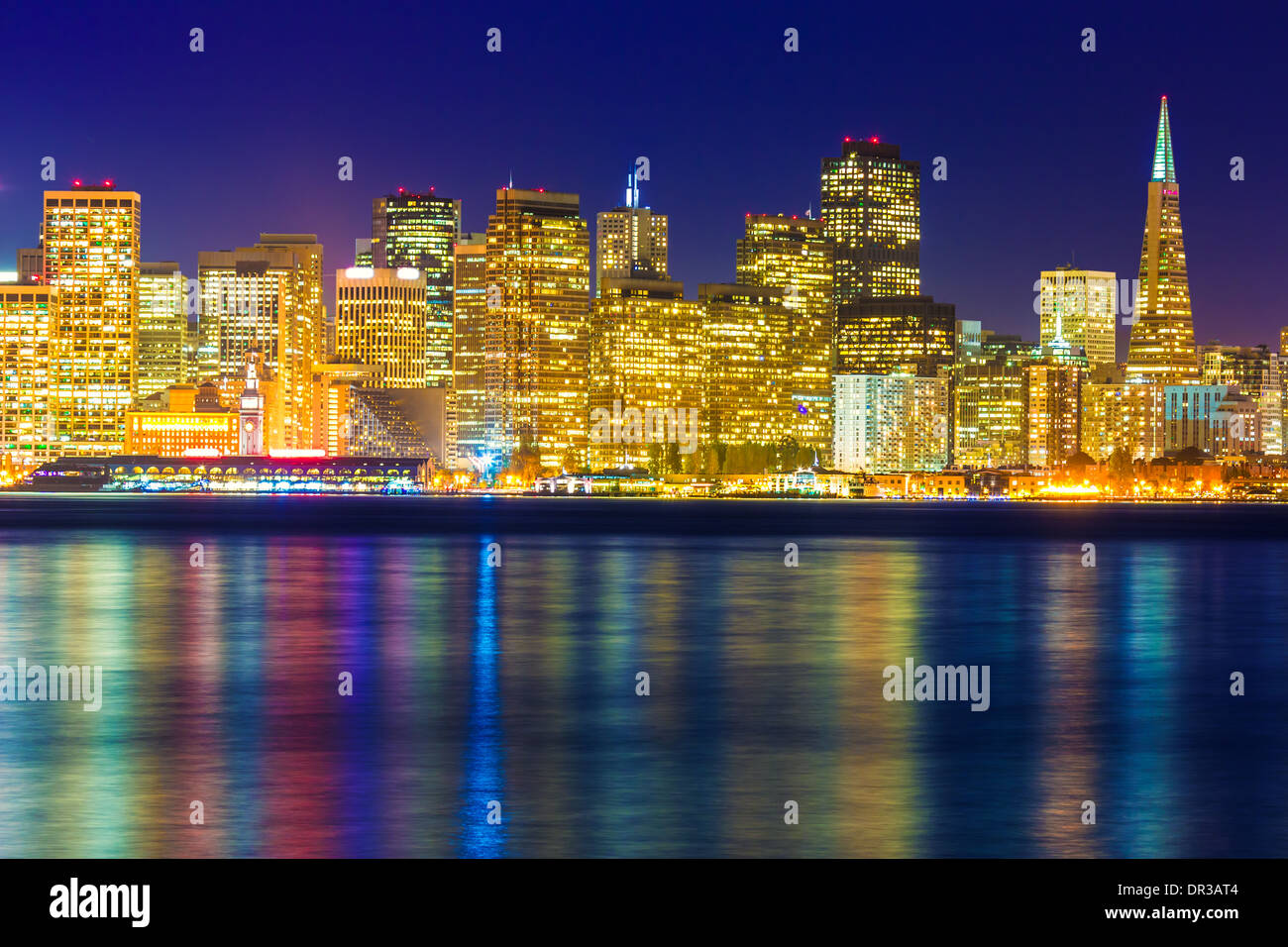 San Francisco sunset skyline in California with reflection in bay water ...