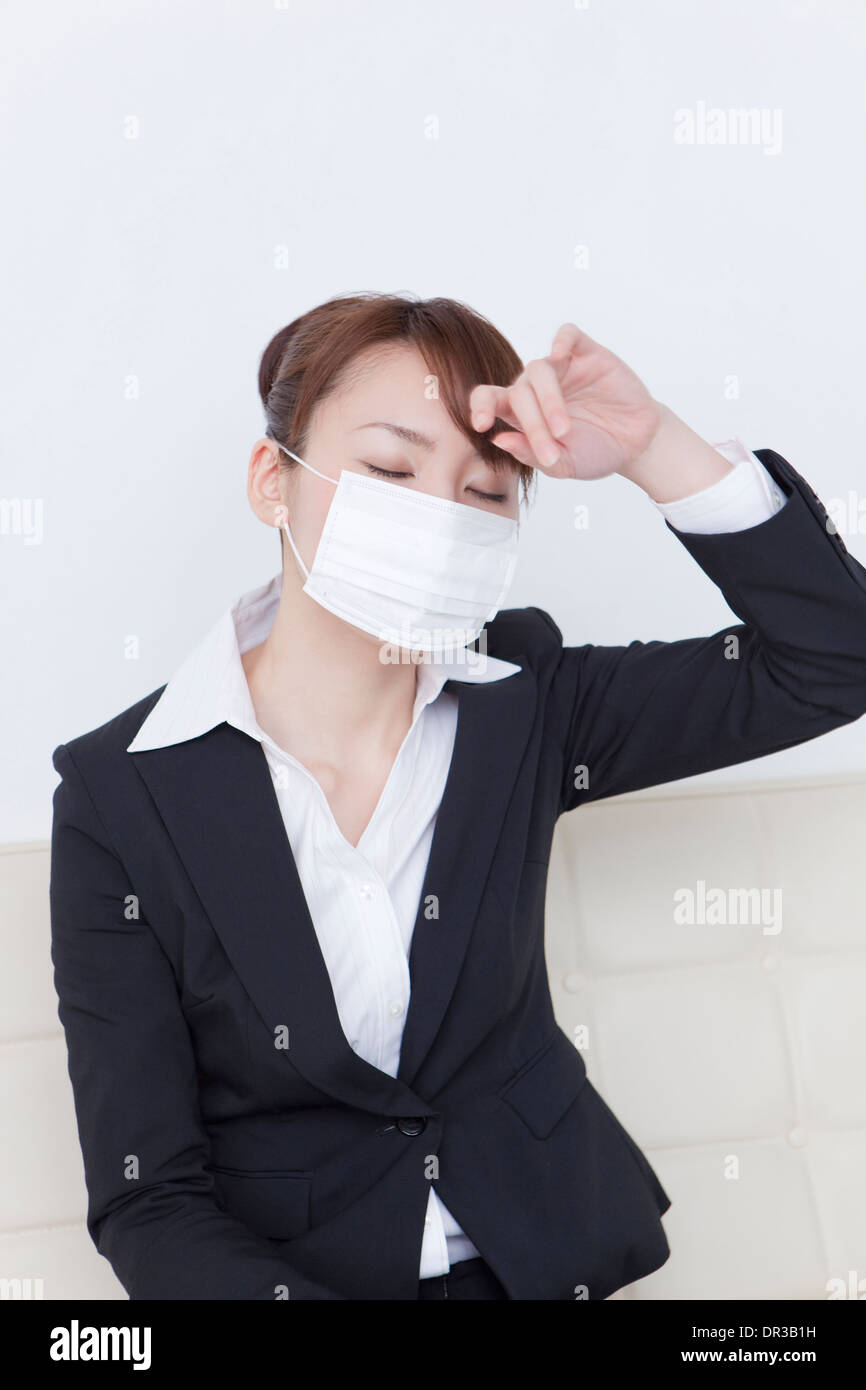 Young business woman wearing flu mask Stock Photo - Alamy