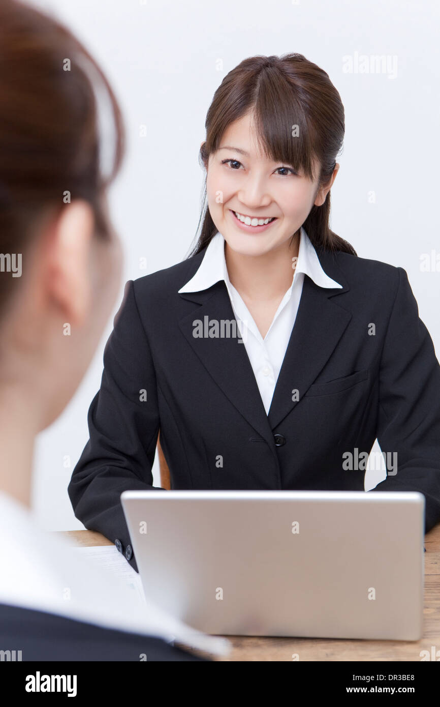 Two young business women having meeting Stock Photo - Alamy