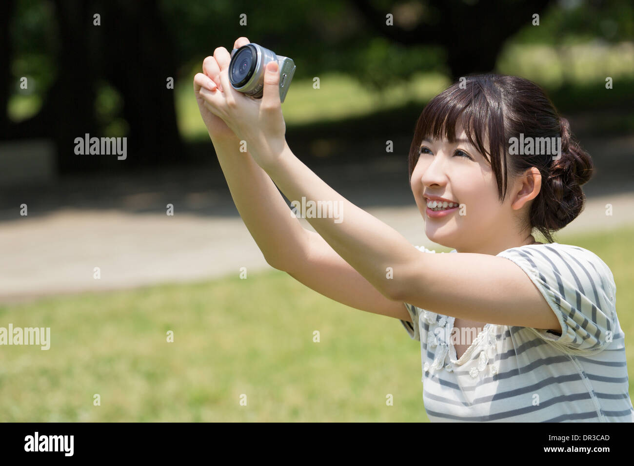 Young woman taking pictures Stock Photo - Alamy