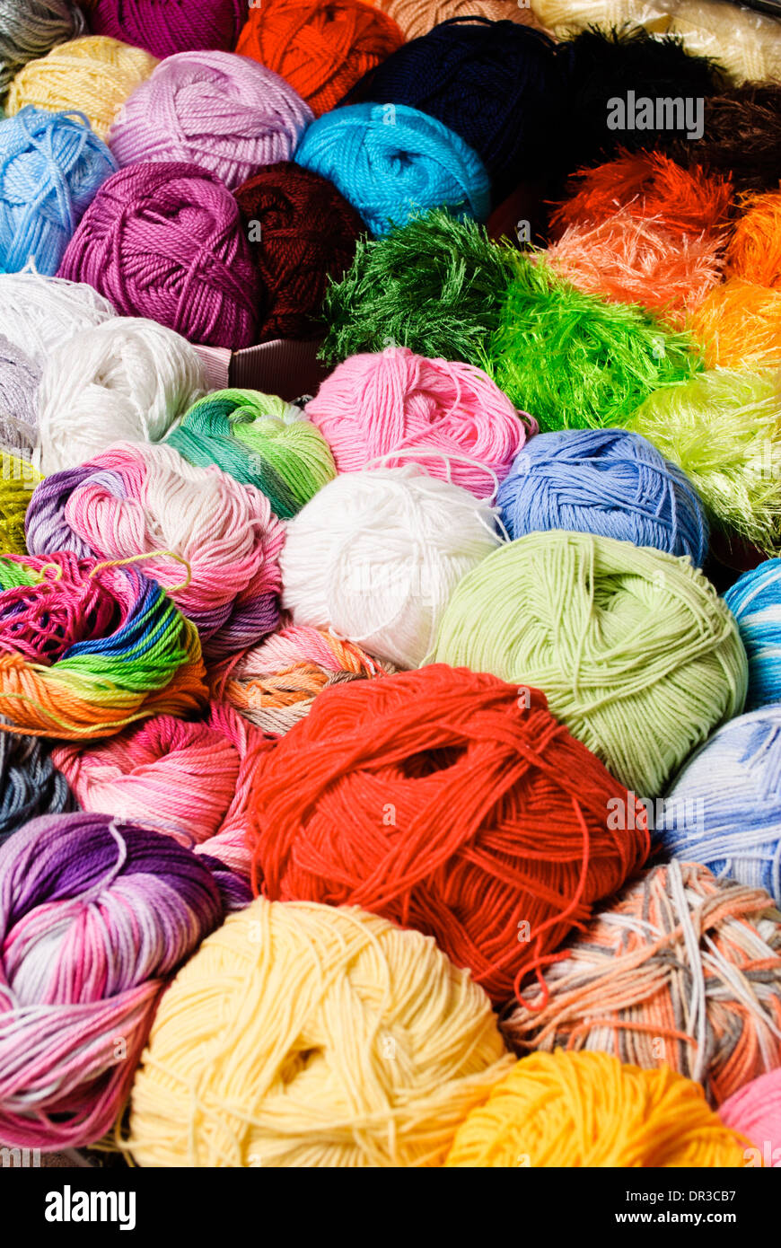 Different color threads on rows in the store Stock Photo - Alamy
