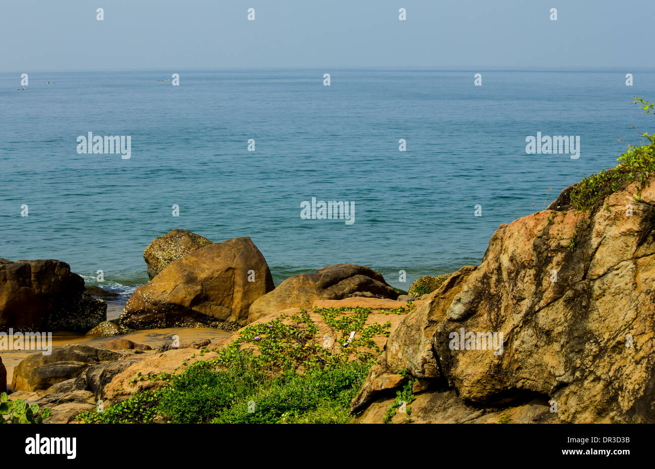 Rocky hill-top on blue sea background Stock Photo - Alamy
