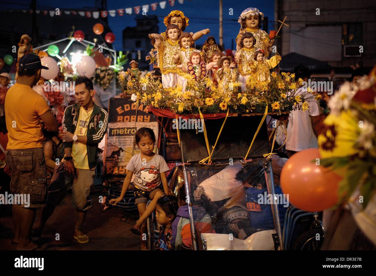 Manila, Philippines. 19th Jan, 2014. Santo Nino statues adorn a pedicab ...