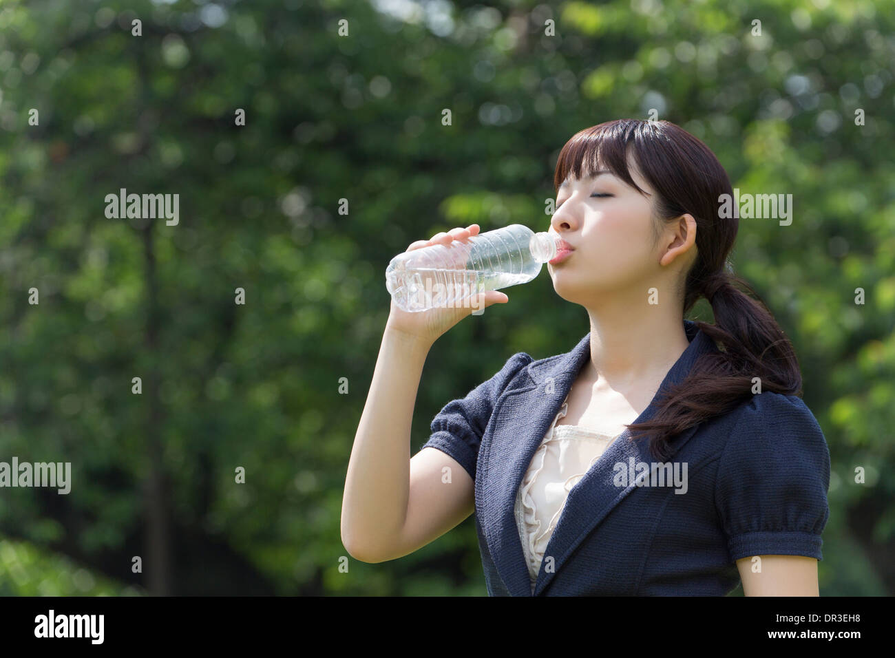 Young woman drinking water in a bottle Stock Photo - Alamy
