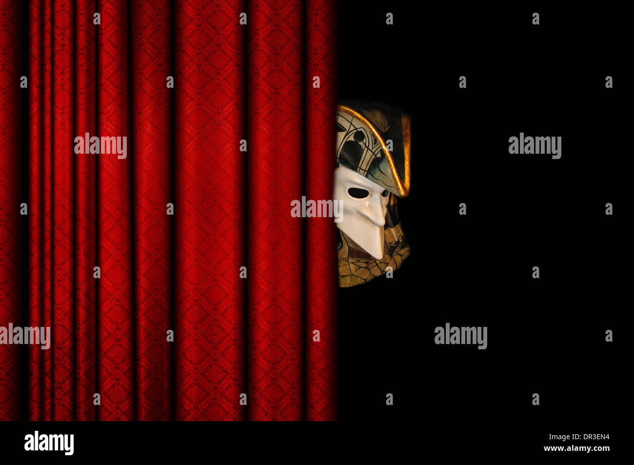 mask behind theater curtains Stock Photo - Alamy