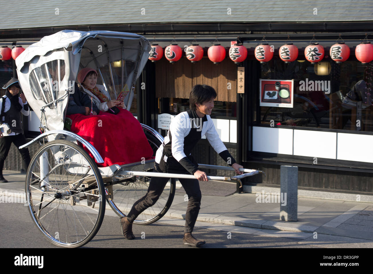Japanese man pulling rickshaw with tourists, Arashiyama, Kyoto, Japan ...