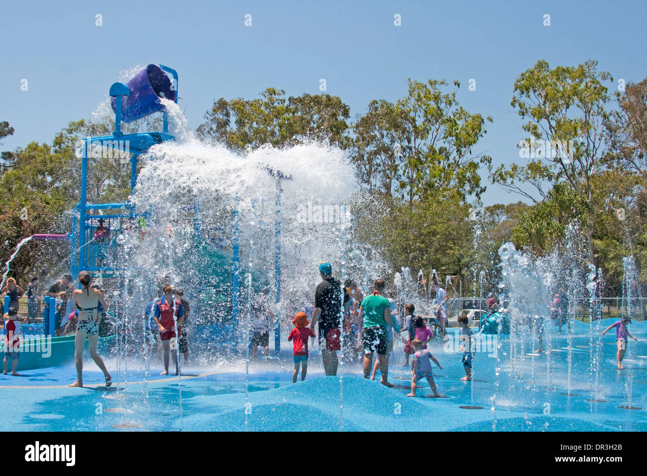 Crowd of adults & children playing in water & getting drenched as water ...