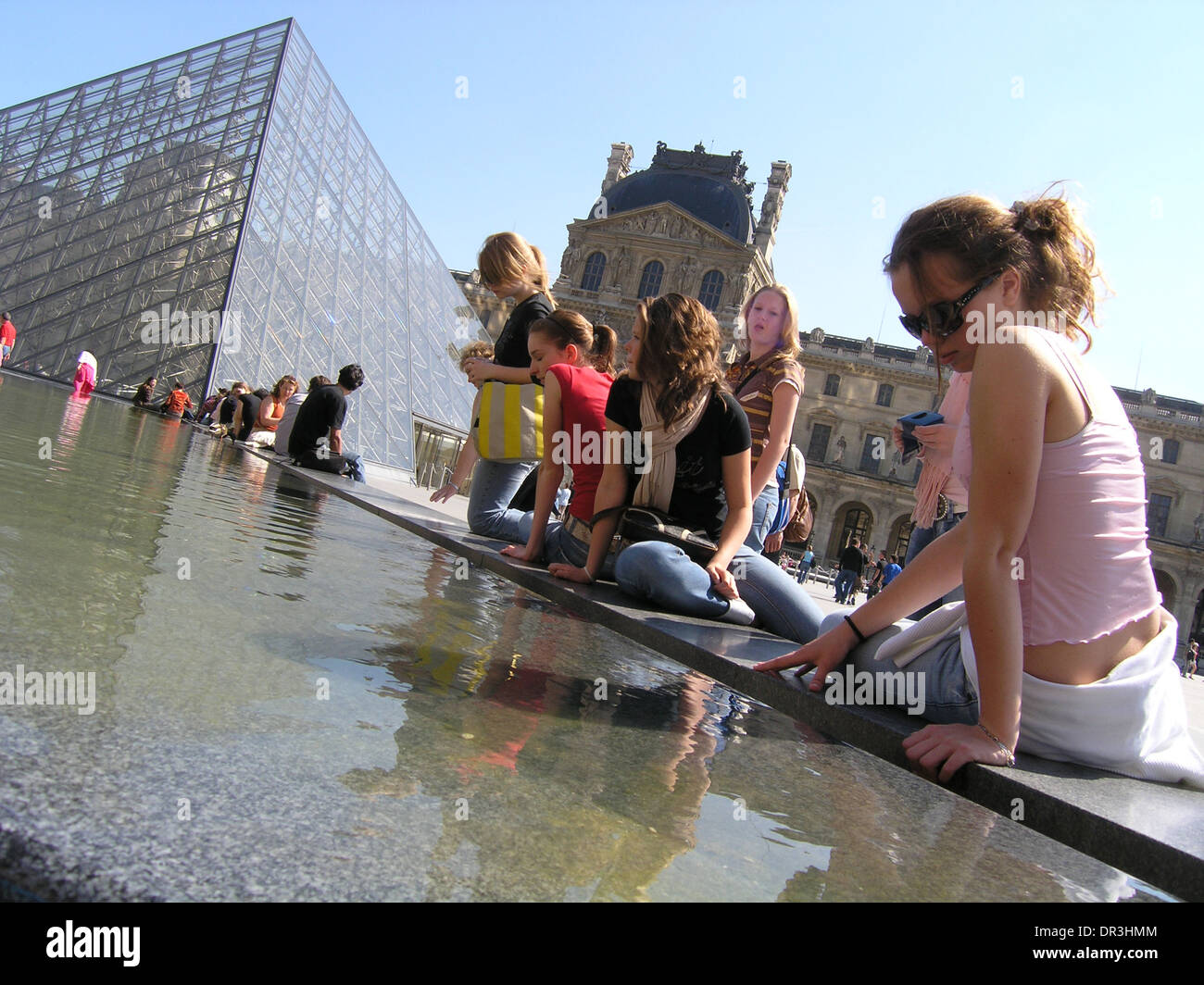 teenage girls by pond at Louvre Pyramid Paris France Stock Photo - Alamy
