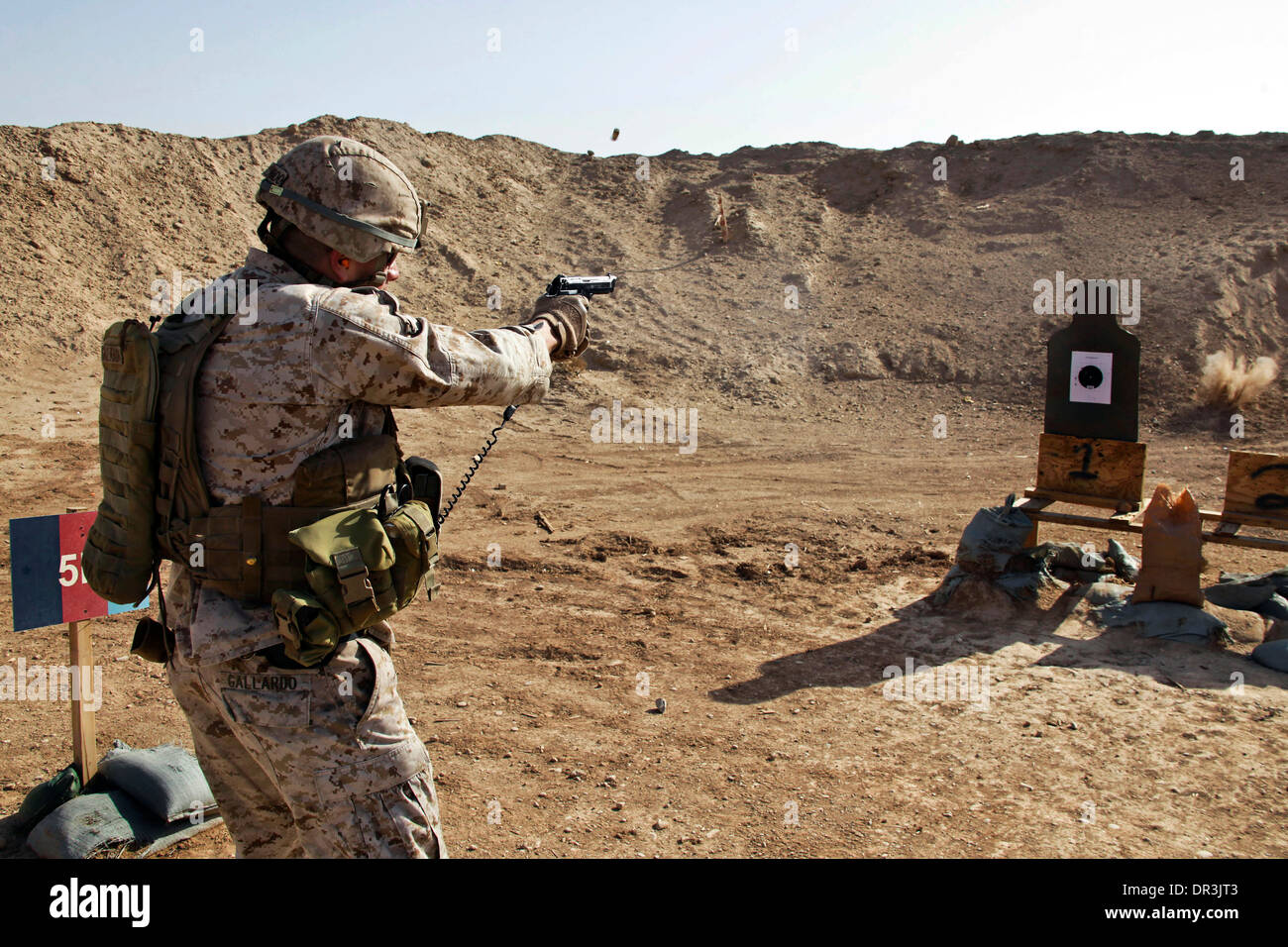 U.S. Marine fires a 9mm pistol during a battle sight zero (BZO) range ...