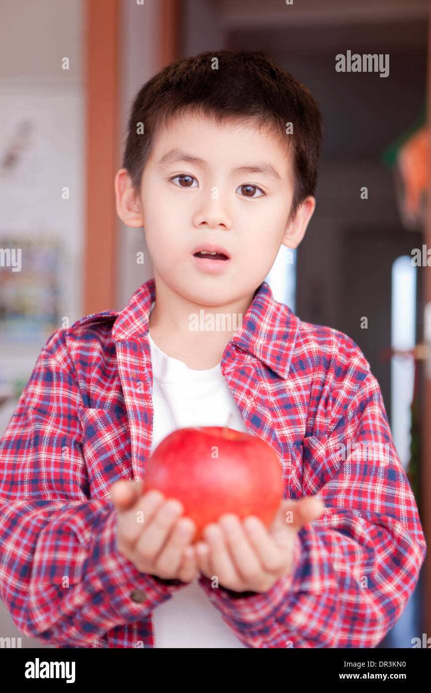 Boy holding apple Stock Photo - Alamy