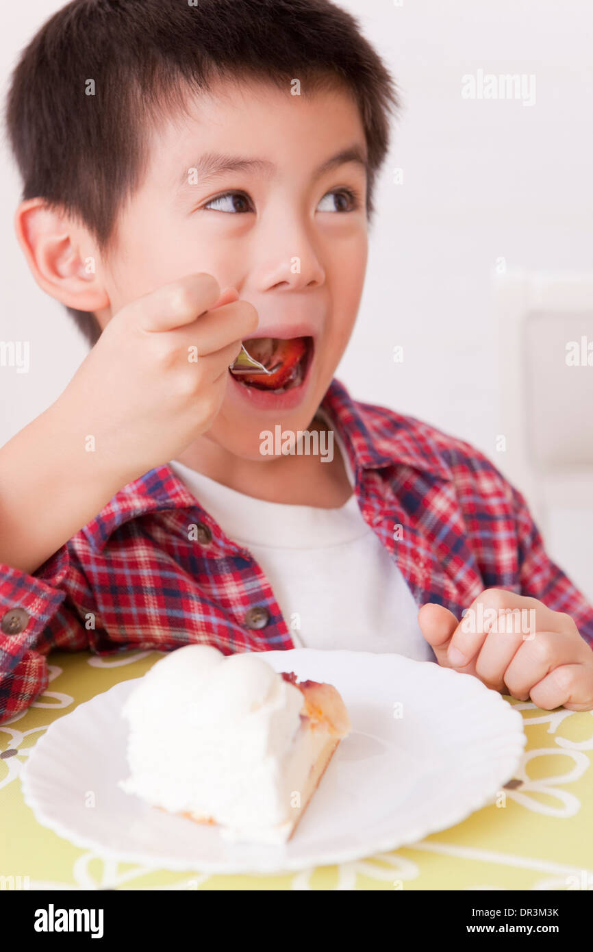 Boy eating cake Stock Photo - Alamy