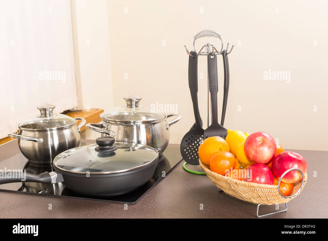 ceramic hob with pans in the kitchen Stock Photo - Alamy