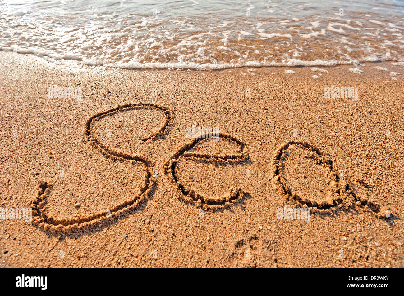 word sea written on the sand on the beach Stock Photo - Alamy
