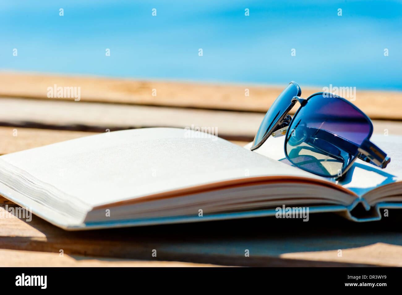 open book and sunglasses on the background of the sea Stock Photo - Alamy