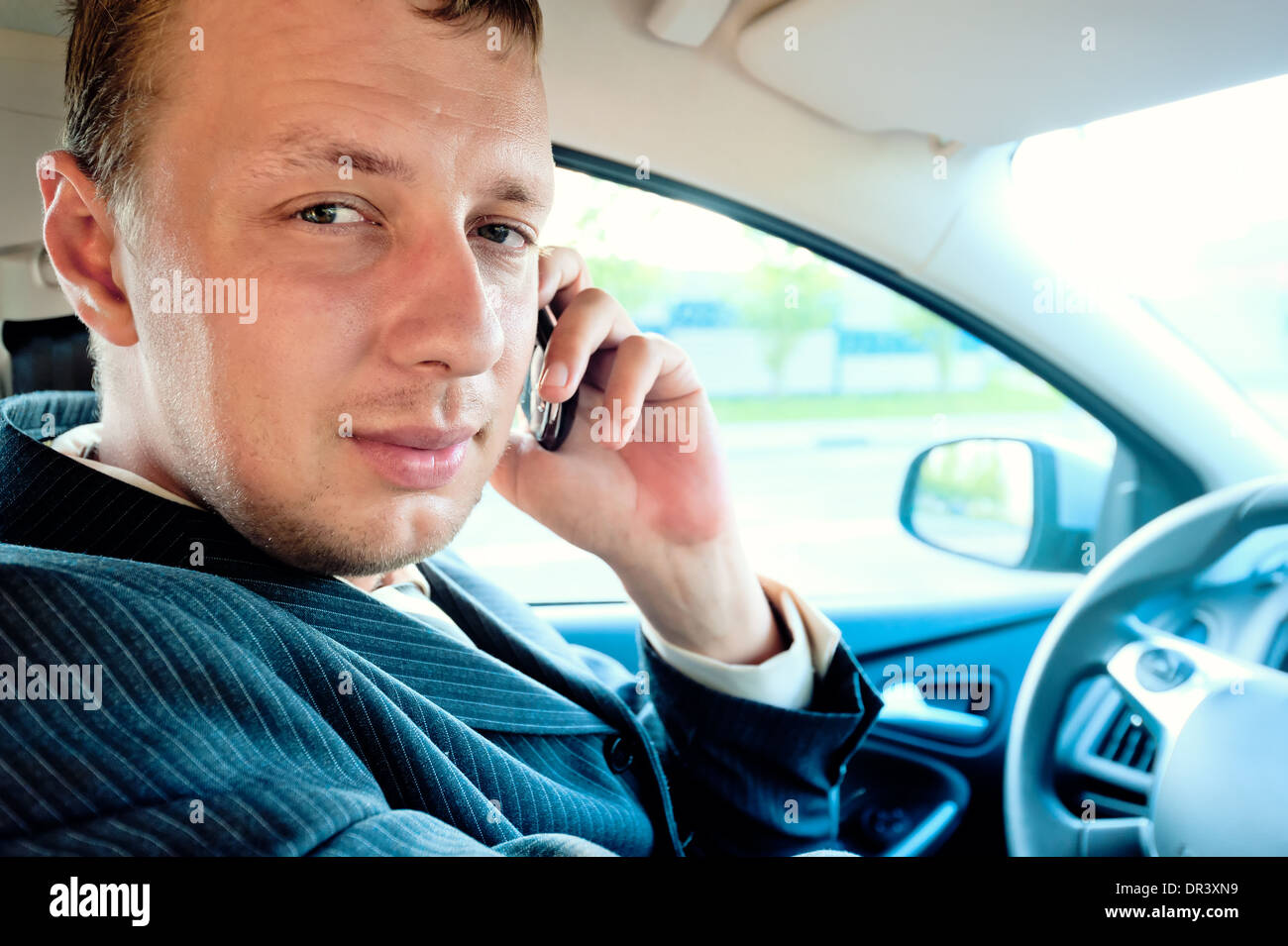 Portrait of a man driving a car with the phone Stock Photo - Alamy