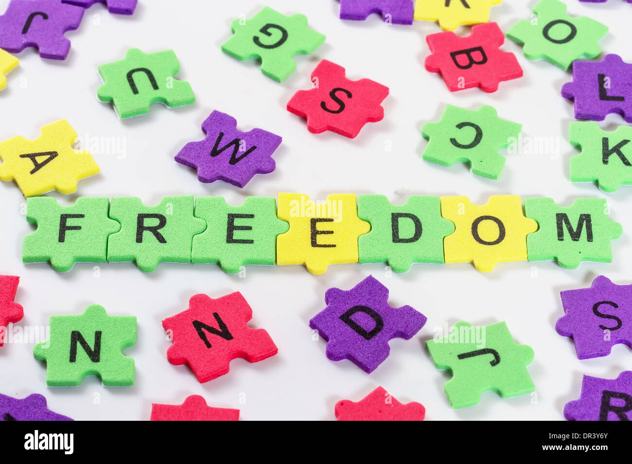 word FREEDOM formed with colorful foam puzzle on white background Stock ...
