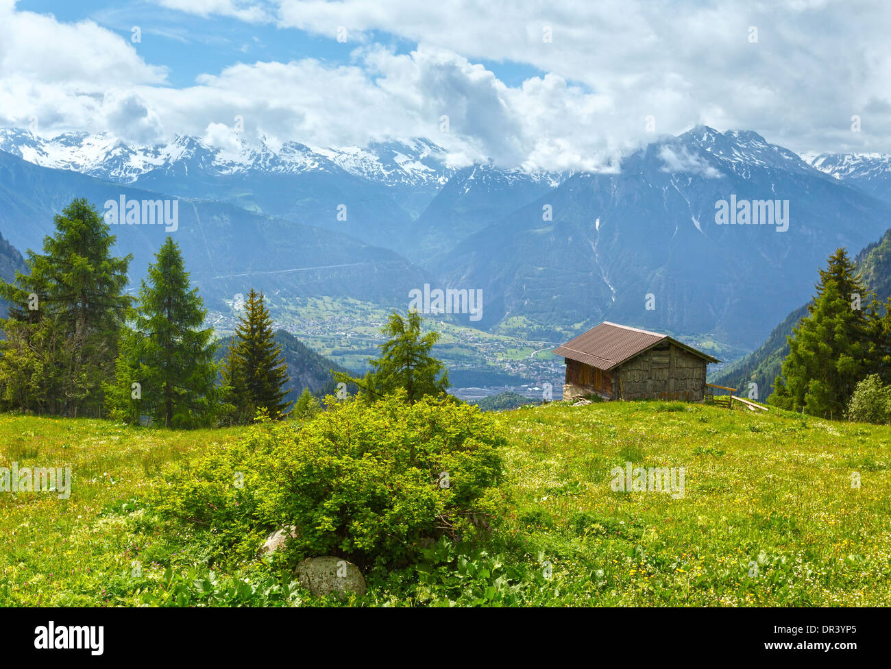 Summer mountain landscape with snow on mount top and house on slope ...