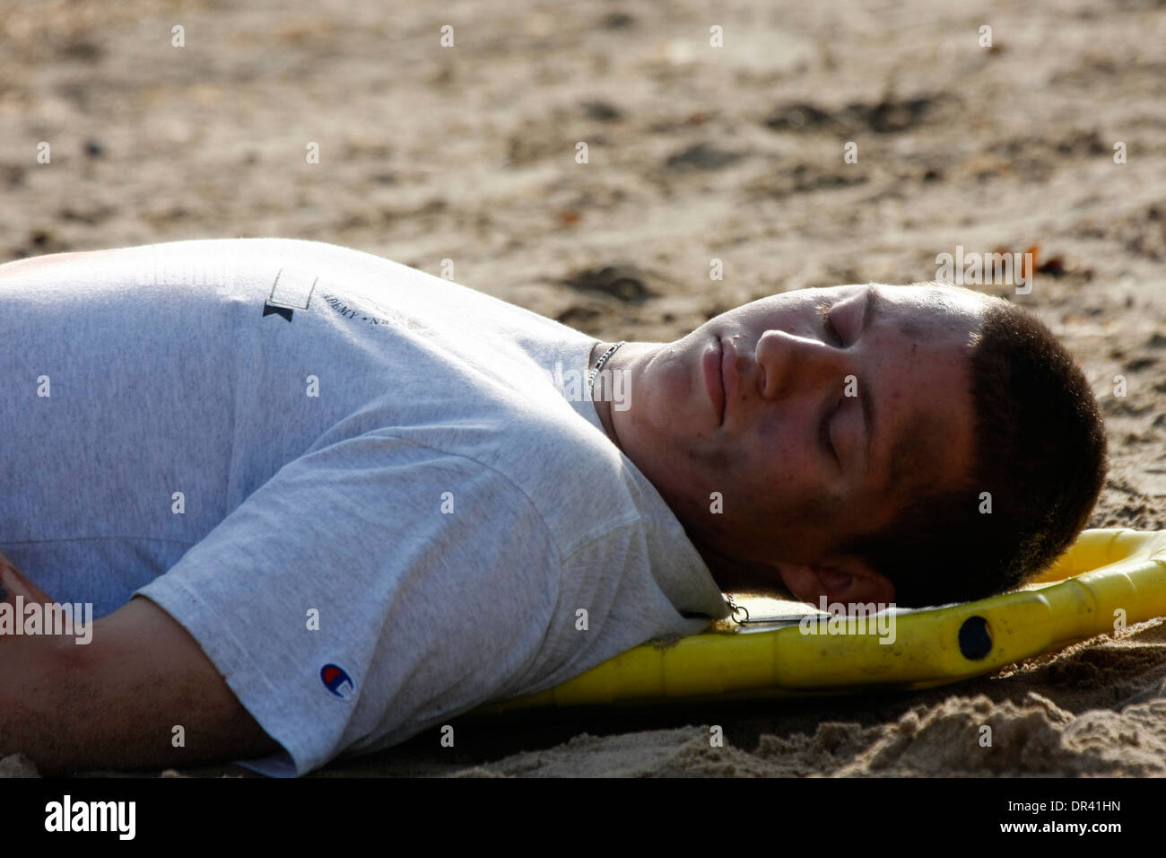 A victim on a backboard injured on a beach Stock Photo - Alamy