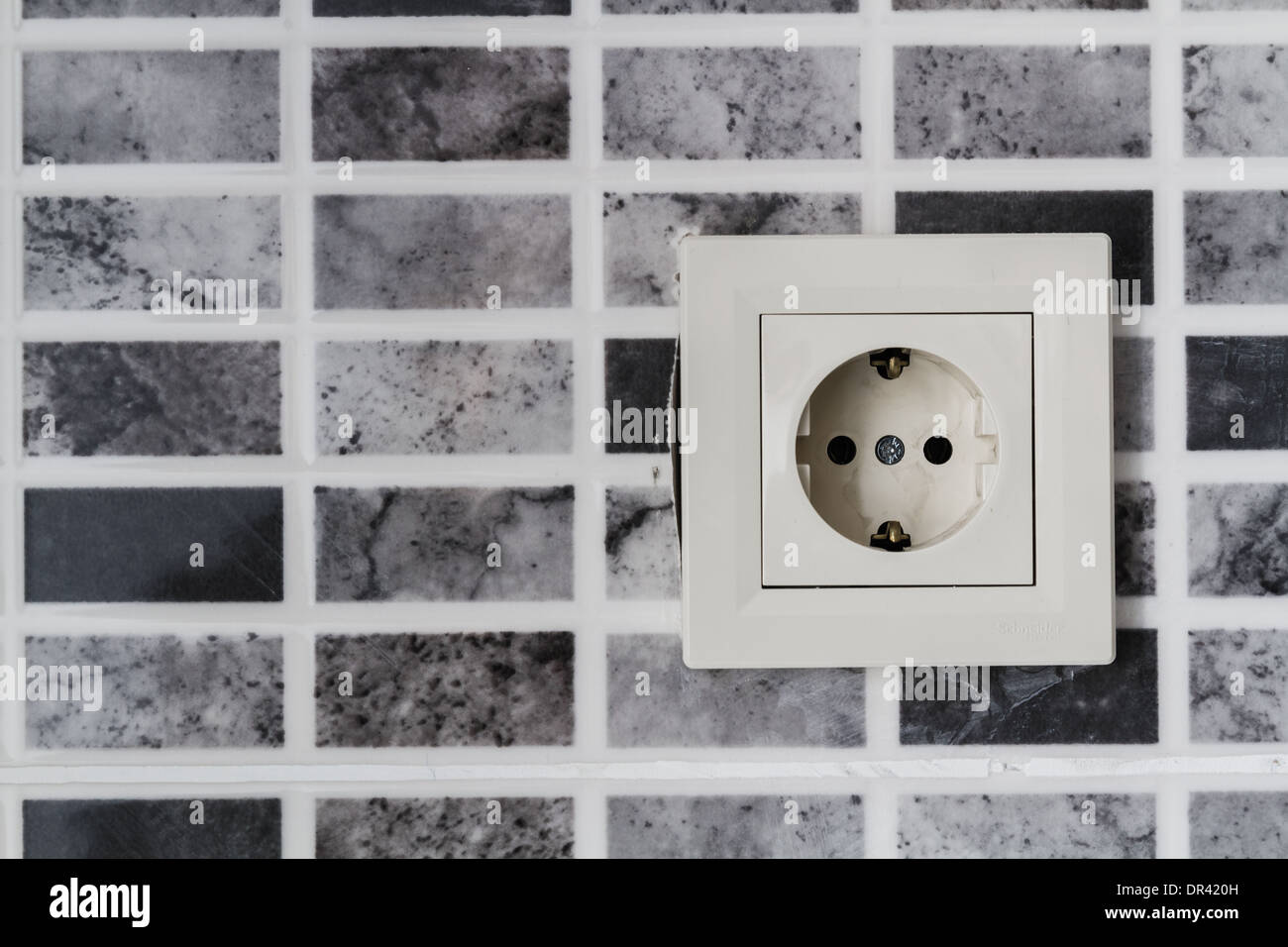Viewe of an electrical outlet on plaid-shaped ceramic tiles Stock Photo ...