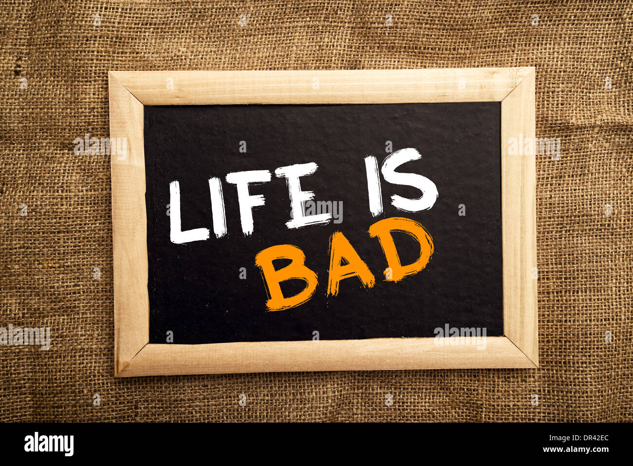 Life is bad, negative message on black board Stock Photo - Alamy