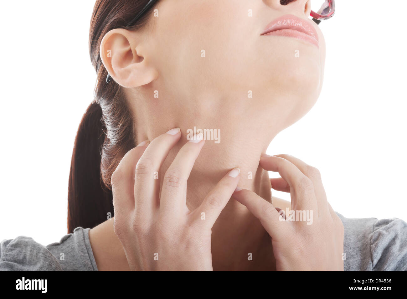 Young woman is scratching her neck. Isolated on white Stock Photo - Alamy