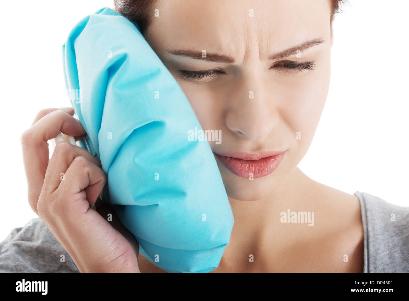 Young woman with toothache and ice bag. Isolated on white Stock Photo ...
