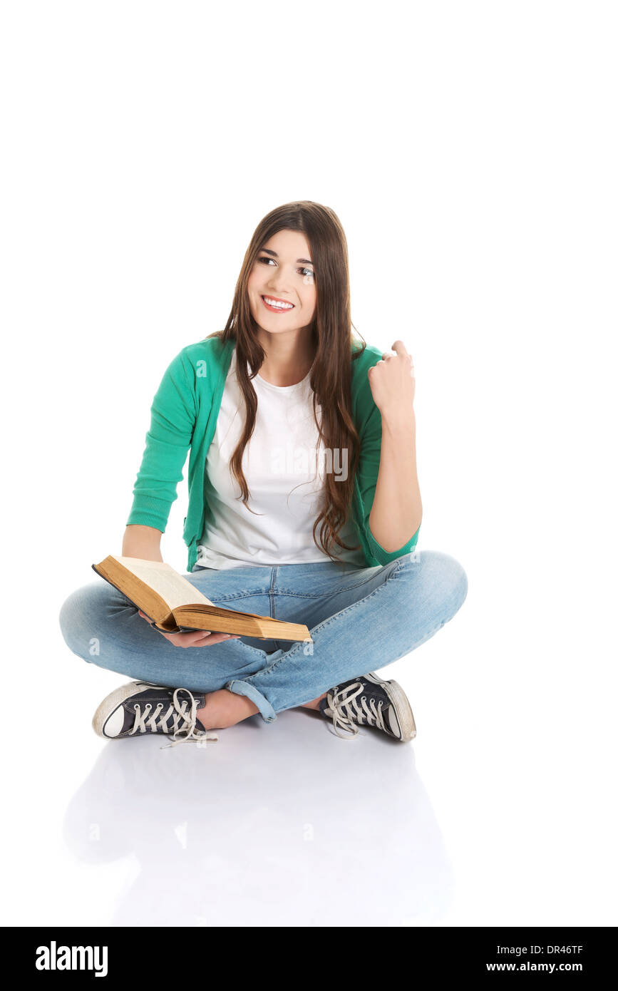 Young beautiful student sitting with book, reading, learning. Isolated ...