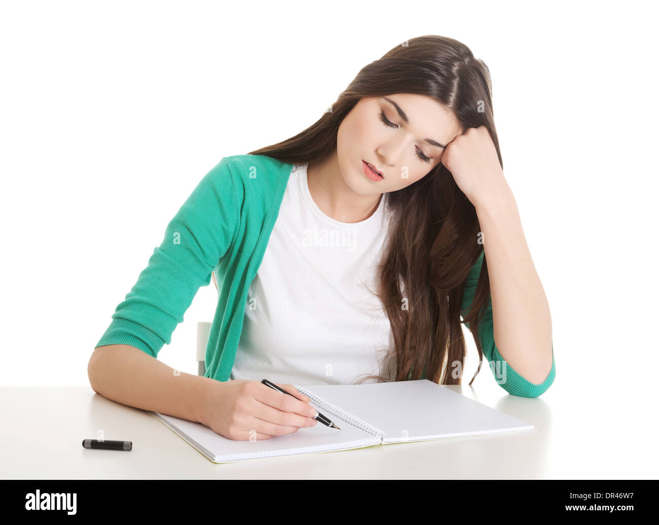 Young casual woman writing in workbook. Isolated on white Stock Photo ...