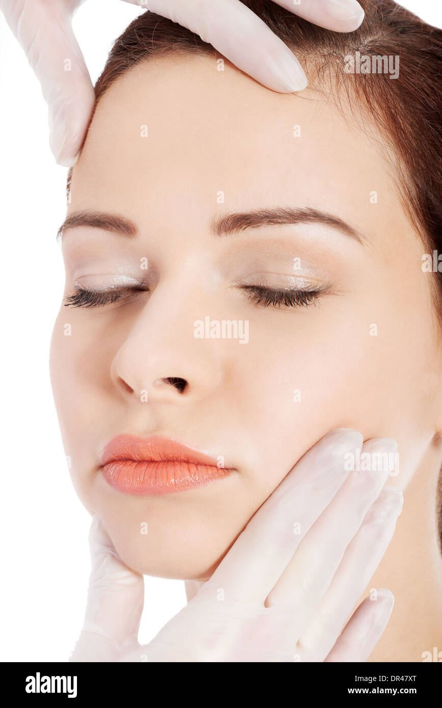 Beautiful woman's face is prepared to plastic surgery. Over white ...