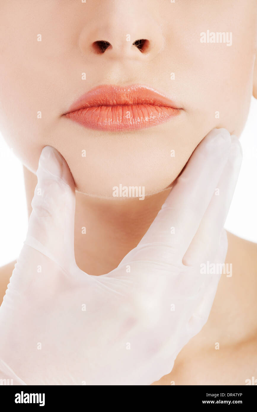 Beautiful woman is prepared to plastic surgery. Over white background ...