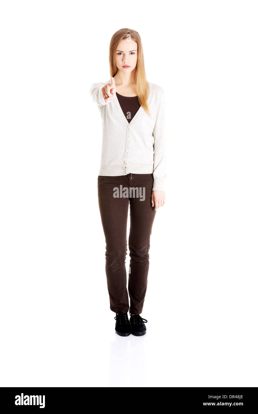 Beautiful casual woman pointing on you and warning or accusing of sth ...