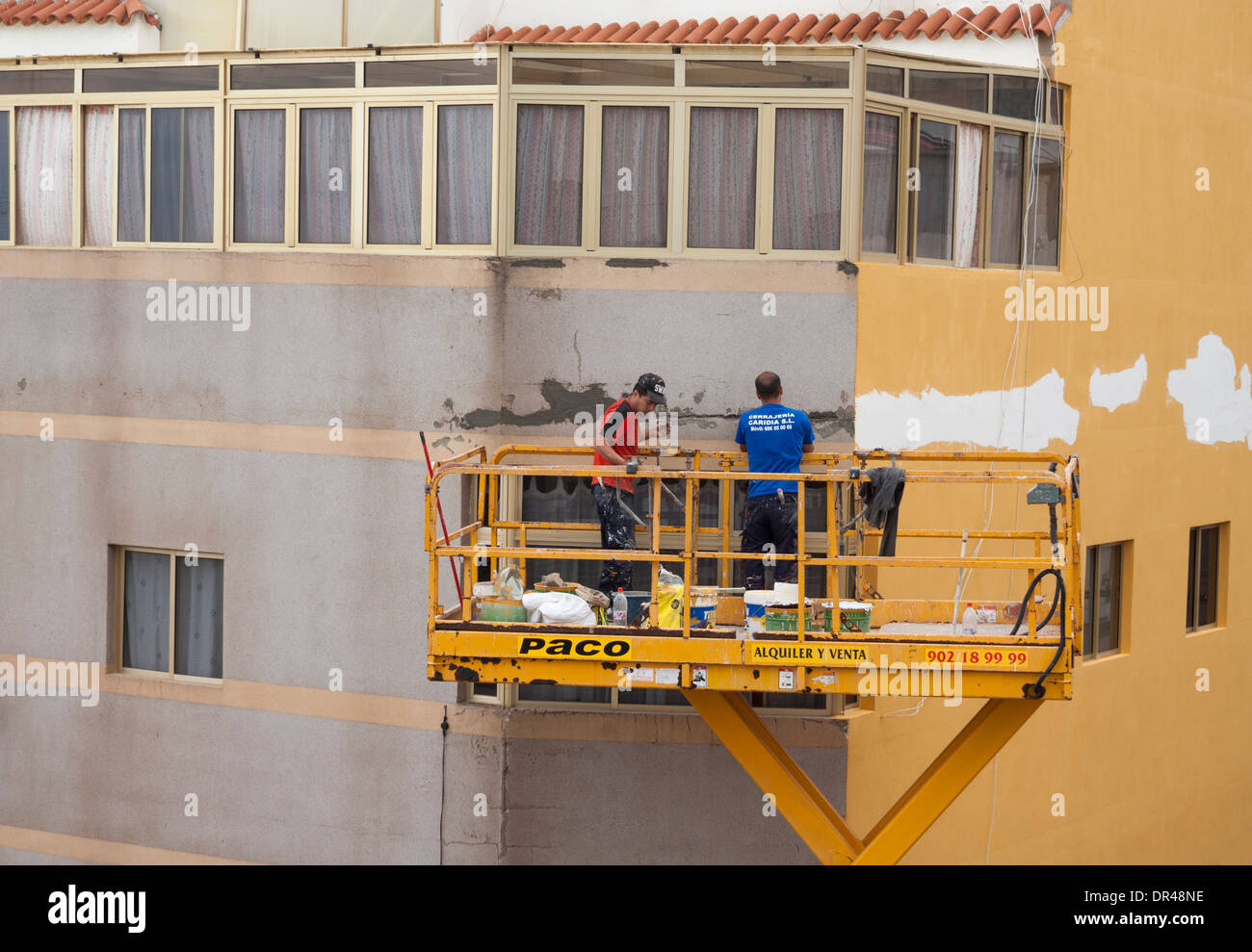 Spanish workmen repairing cracks on block of apartments in Spain Stock ...
