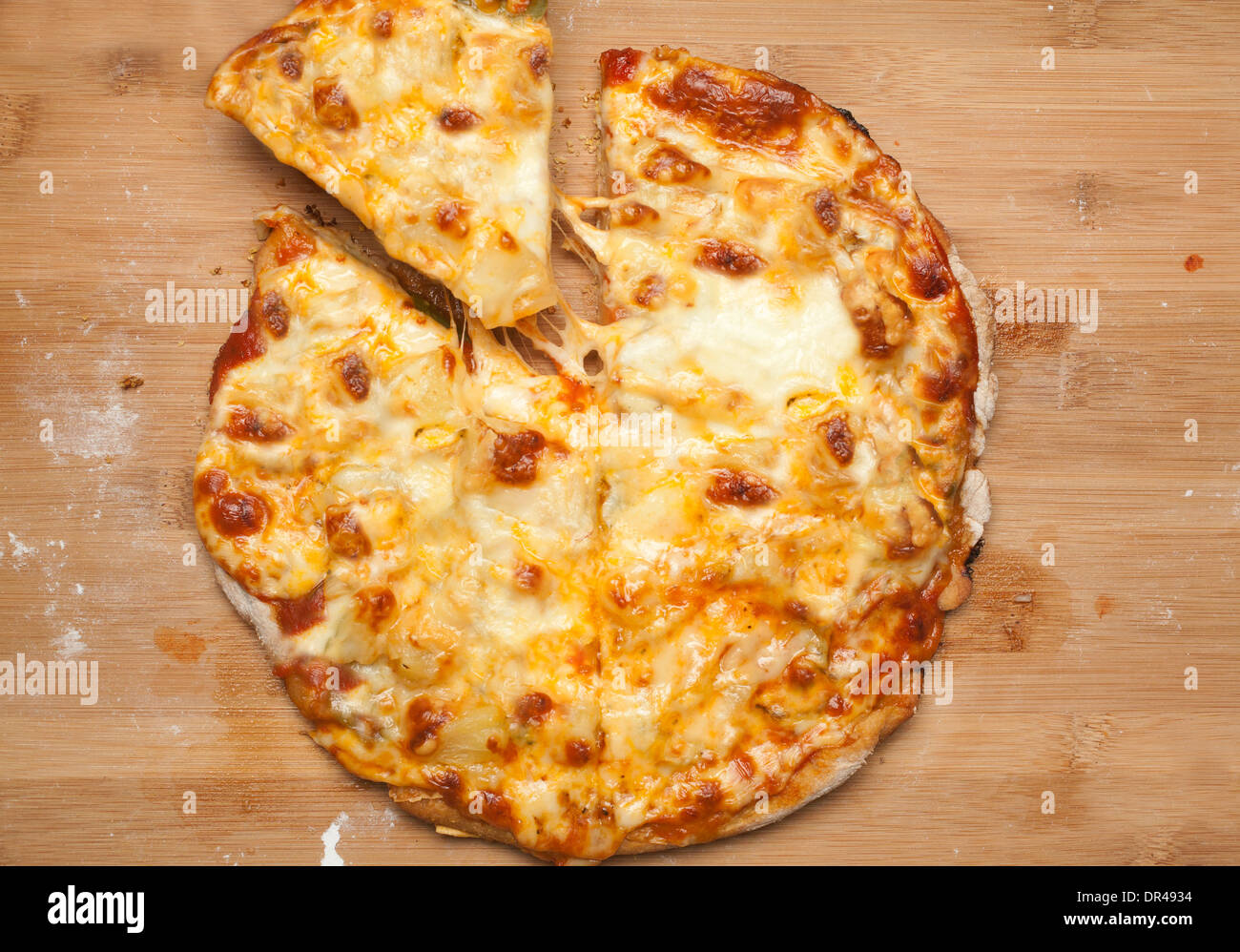 Whole cheese pizza with first slice being taken Stock Photo - Alamy