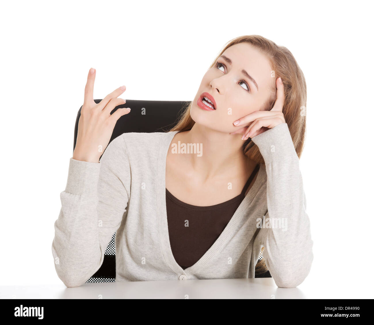 Beautiful casual woman, sitting and looking up. Isolated on white Stock ...