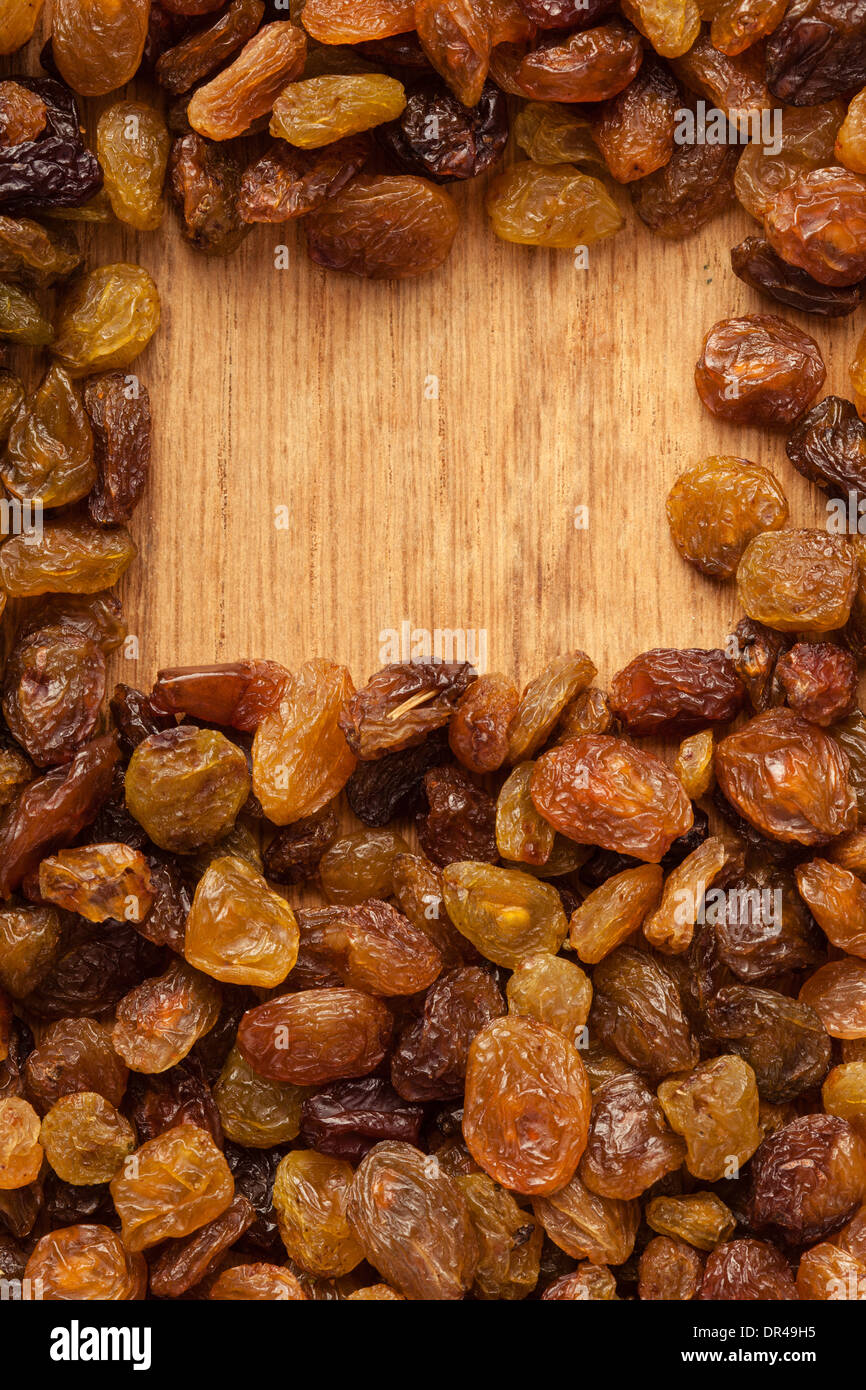 Healthy food organic nutrition. Border frame of raisin on wooden table ...