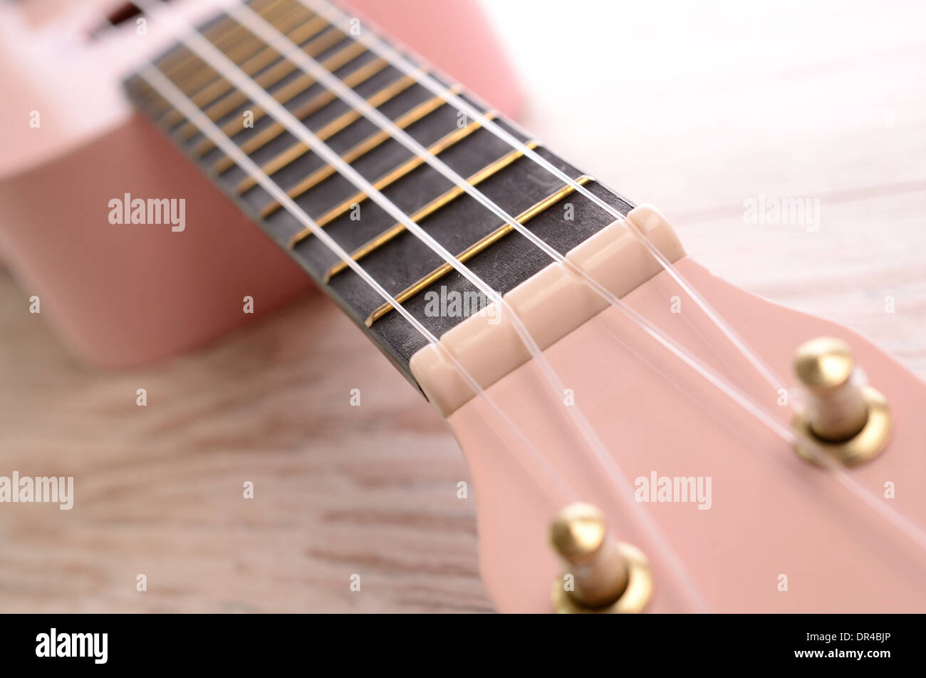 Closeup of a pink ukulele Stock Photo - Alamy