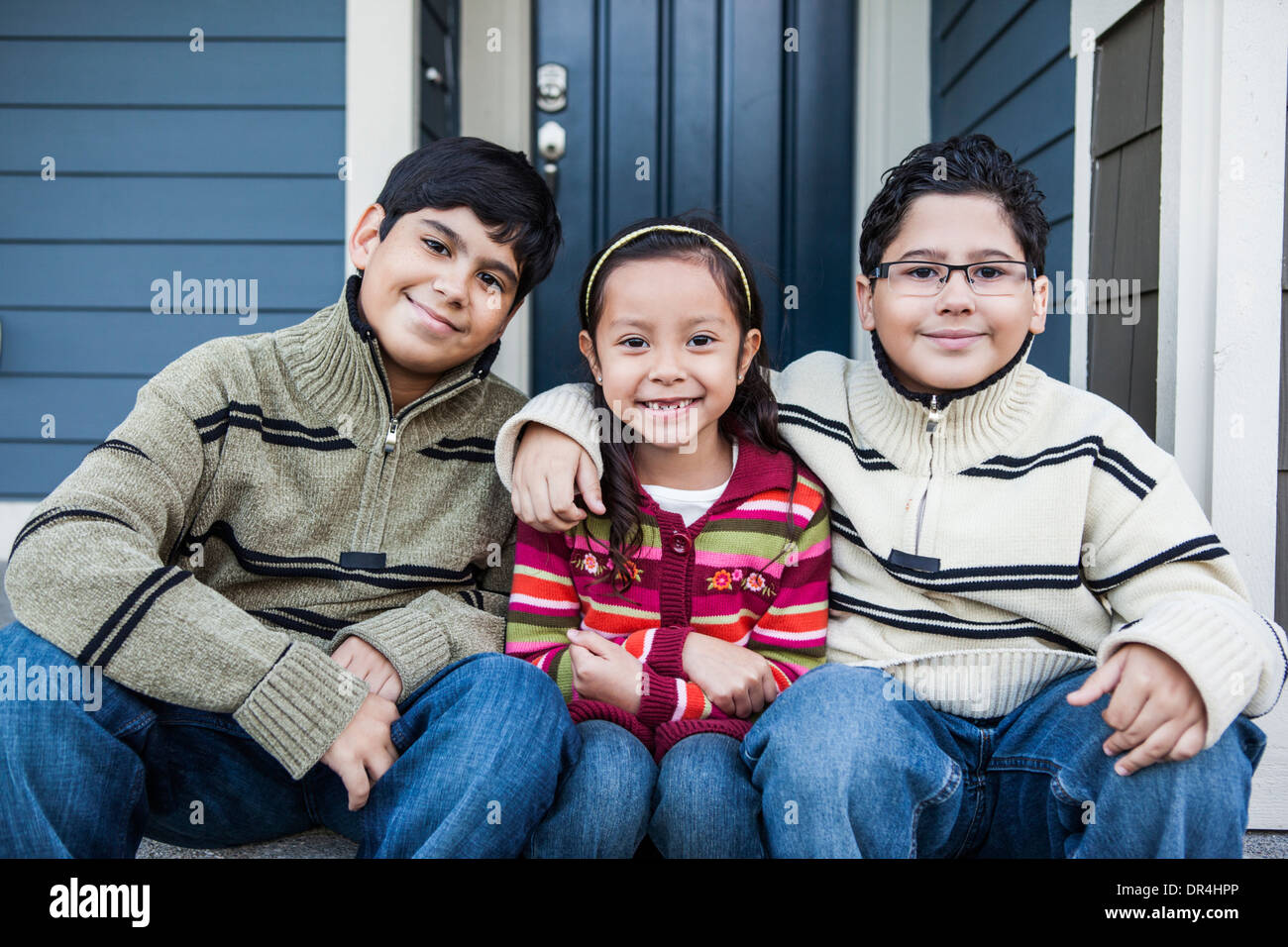 Children smiling together on front stoop Stock Photo - Alamy