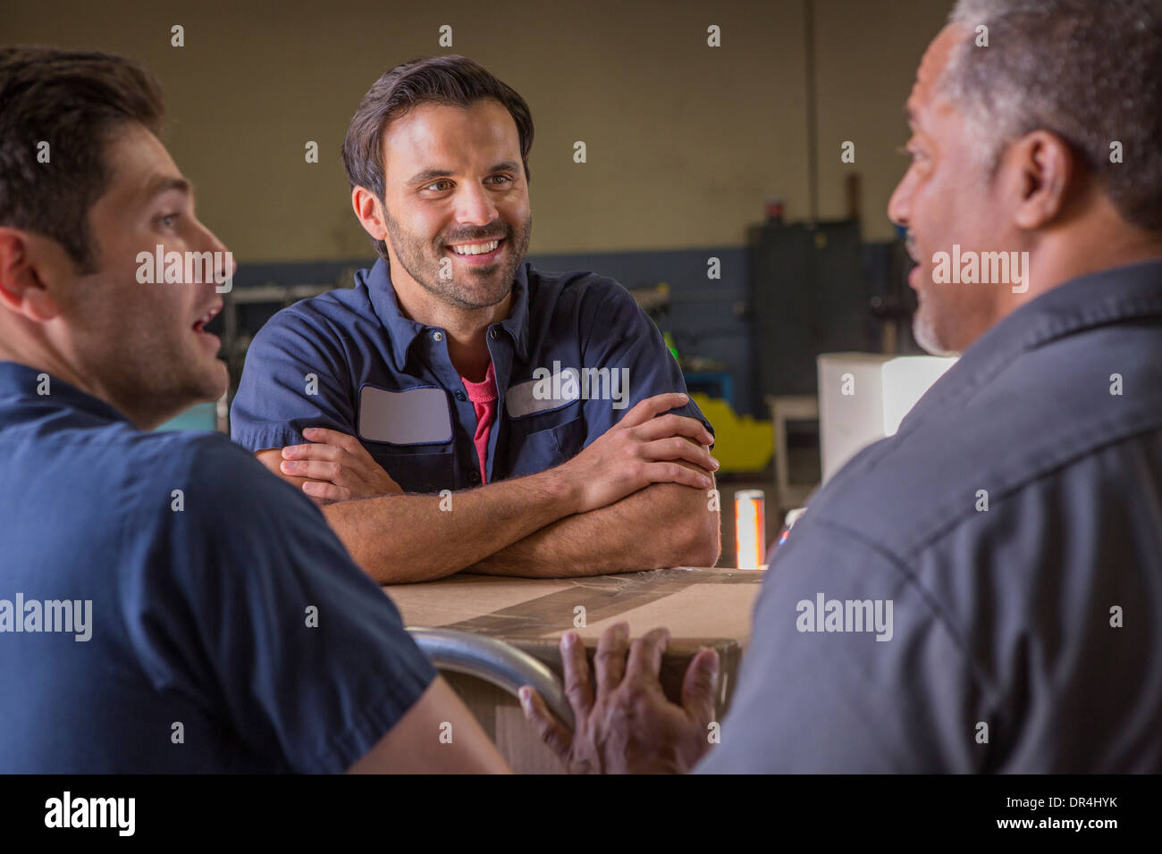Workers talking in warehouse Stock Photo - Alamy
