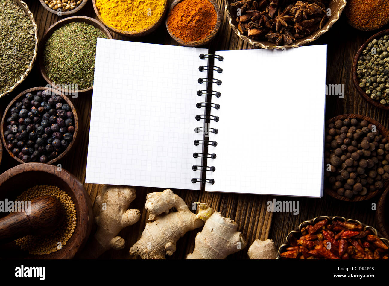 Cookbook and various spices Stock Photo - Alamy