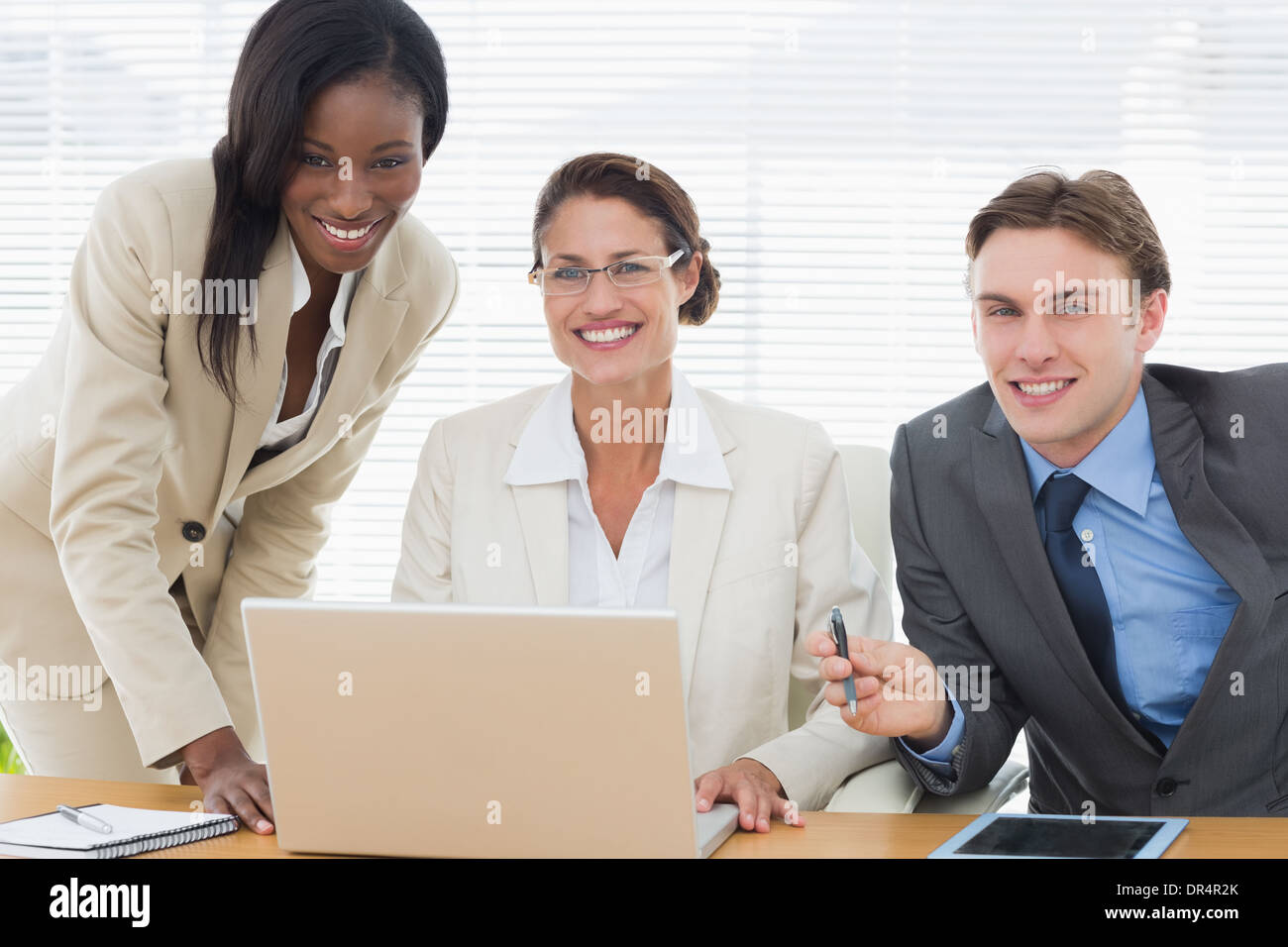 Male colleague smiling meeting table hi-res stock photography and ...
